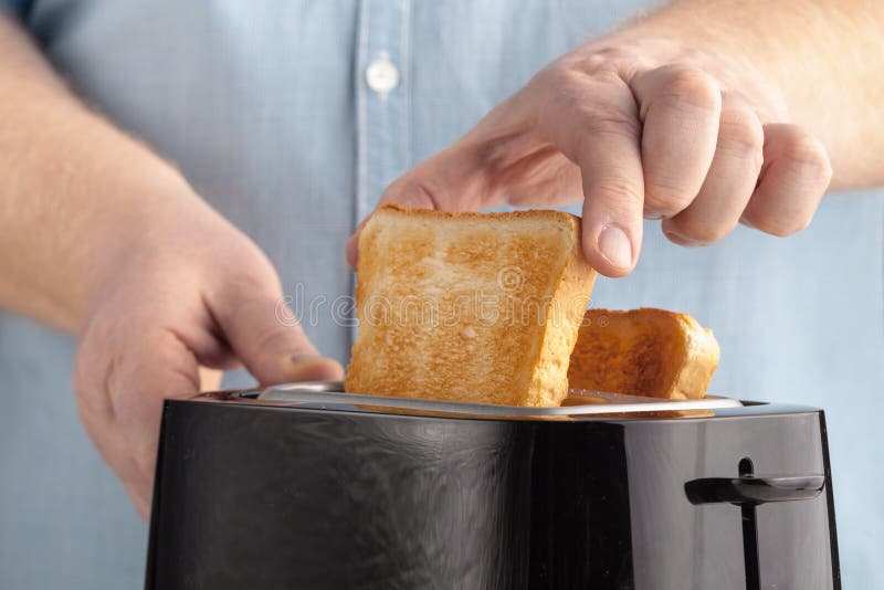 Close-up Shot of Man Taking Toast from Toaster Stock Image - Image of ...