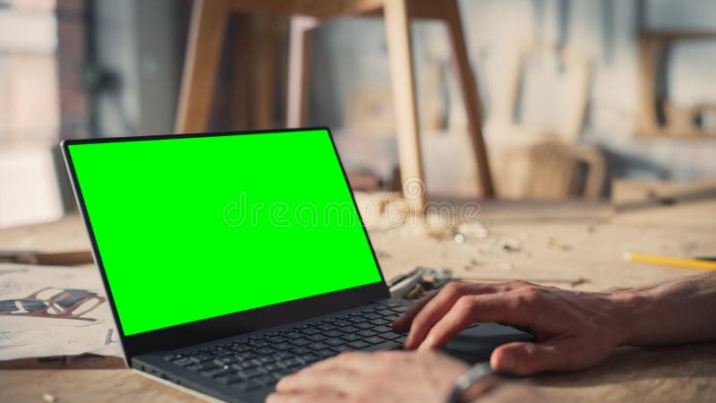 Close Up Shot of a Person Using Laptop Computer with Green Screen ...