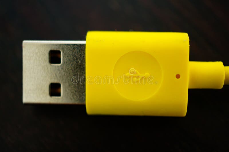 Close Up Shot of a Plug of a Yellow USB Isolated on a Dark Background ...