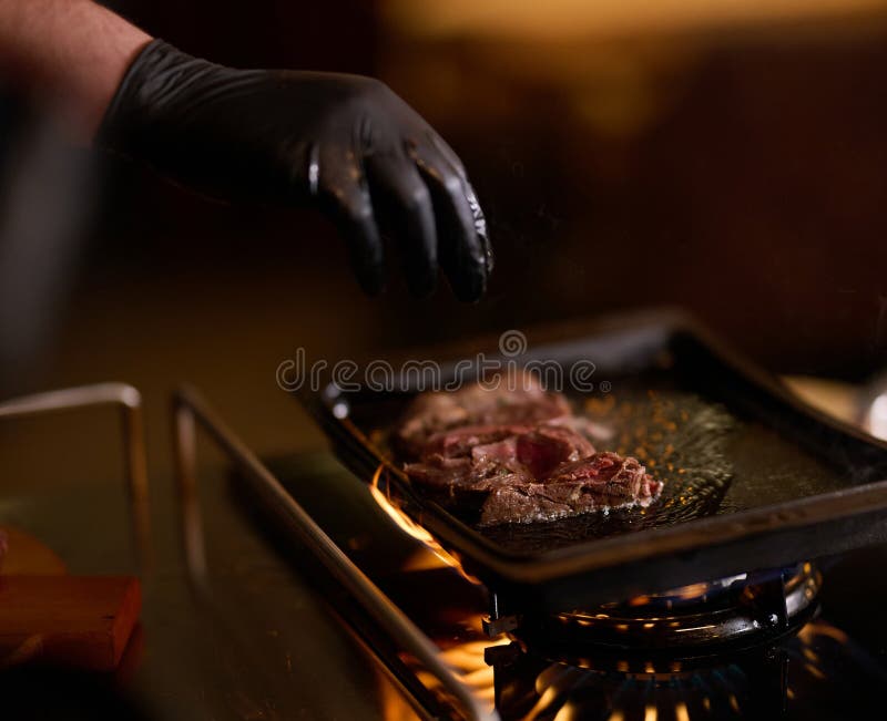 Close-up Shot, a Professional Chef Expertly Prepares a Delicious Steak ...