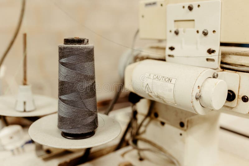 Close Up Shot of a Reel of Thread Lying beside a Vintage Sewing Machine ...