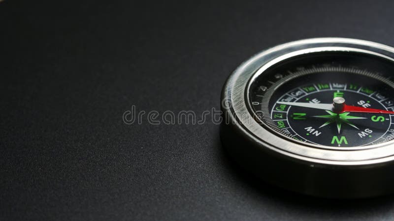 Close-Up View of a Compass on a Dark Table Indicating Magnetic North ...