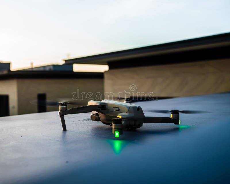 Close-up Shot of a Small Quadcopter Drone on a Rooftop, Its Four ...