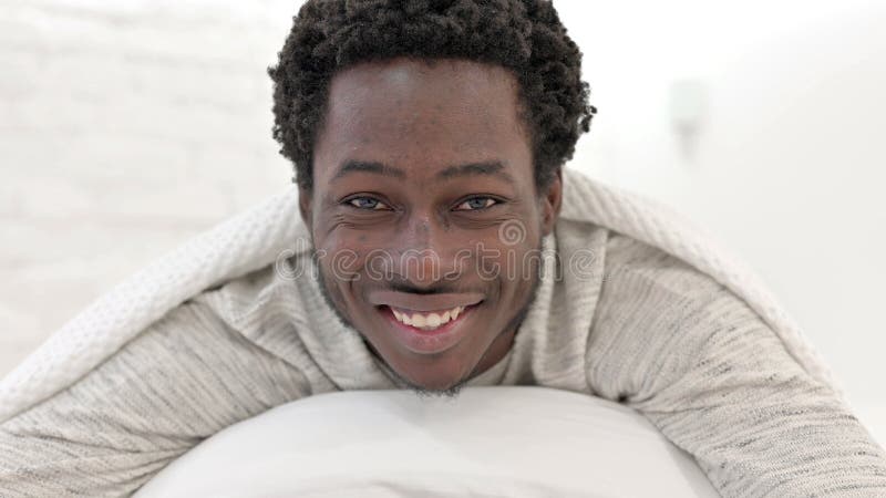 Close-up Shot of Smiling African Man in Bed Stock Photo - Image of ...