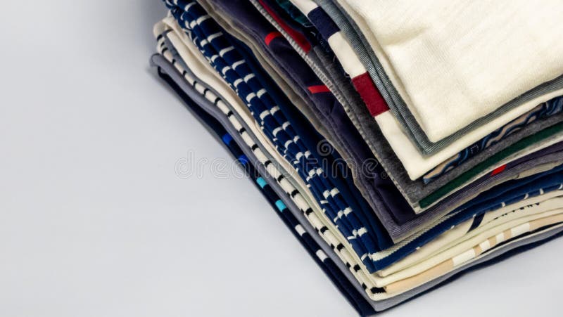 A Neat Stack of Folded Clothes on a White Background Stock Image ...