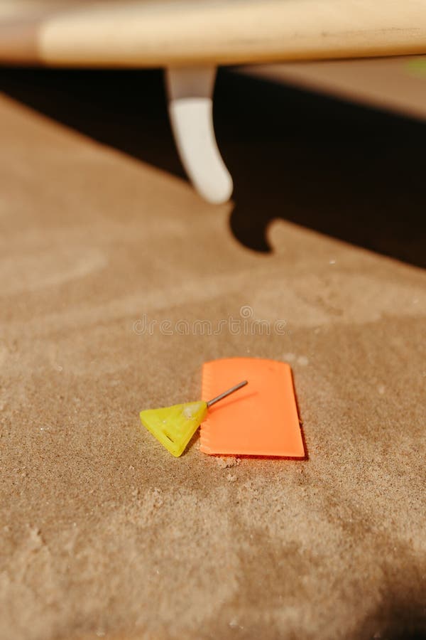 Close-up Shot of a Surfboard Fin Key Lying on a Sandy Beach Stock Image ...