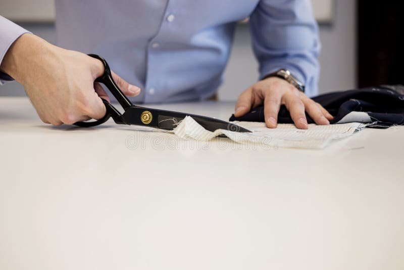 Close-up Shot of Tailor Cutting Textile Using Scissors Stock Photo ...
