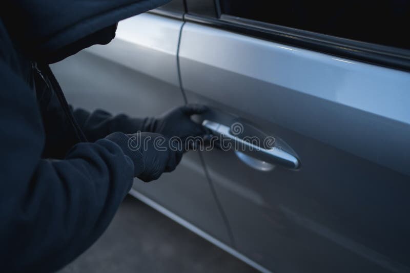 Close-up Shot of a Thief Stealing a Car with a Screwdriver. Car Theft ...