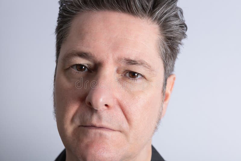 Close-up Shot of a 50-year-old Man with Serious Expression and Fixed ...