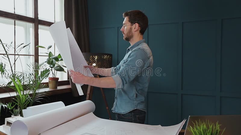 Close Up Shot of Young Man Hands Engineer Opening the Paper and ...