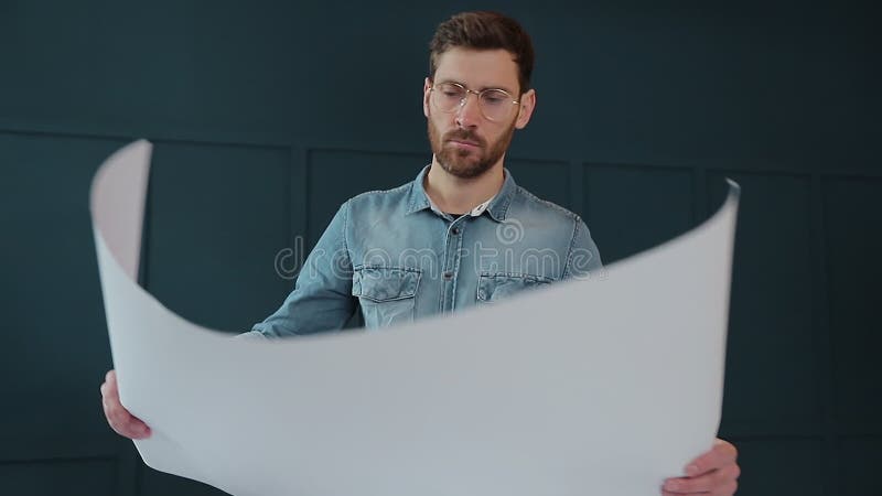 Close Up Shot of Young Man Hands Engineer Opening the Paper and ...