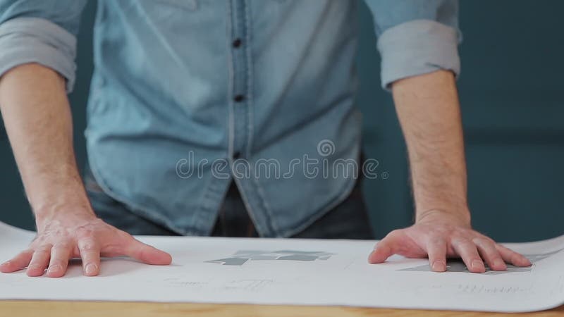Close Up Shot of Young Man Hands Engineer Opening the Paper and ...