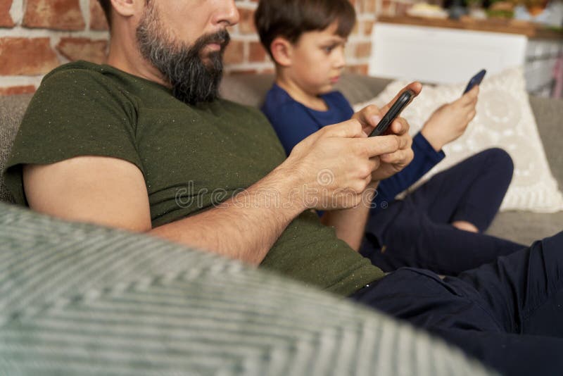 Using mobile by family stock photo. Image of indoors - 224197276