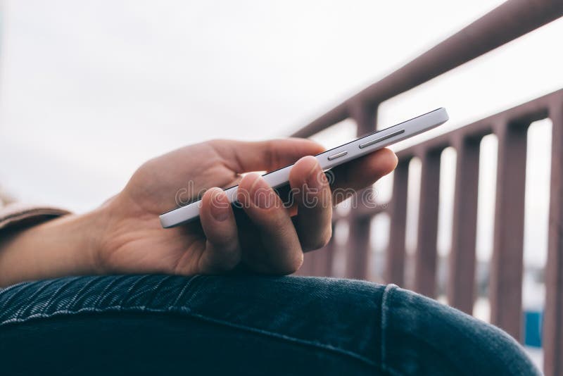 Close-up Side View of a Female Hand Holding a Phone Stock Photo - Image ...