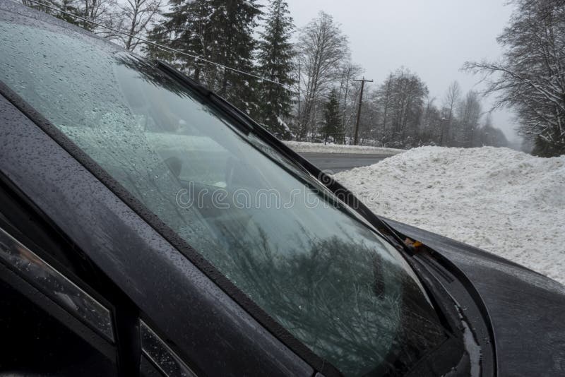 Close Up, Side View of the Icy Windshield of a Car Pulled Over during a ...