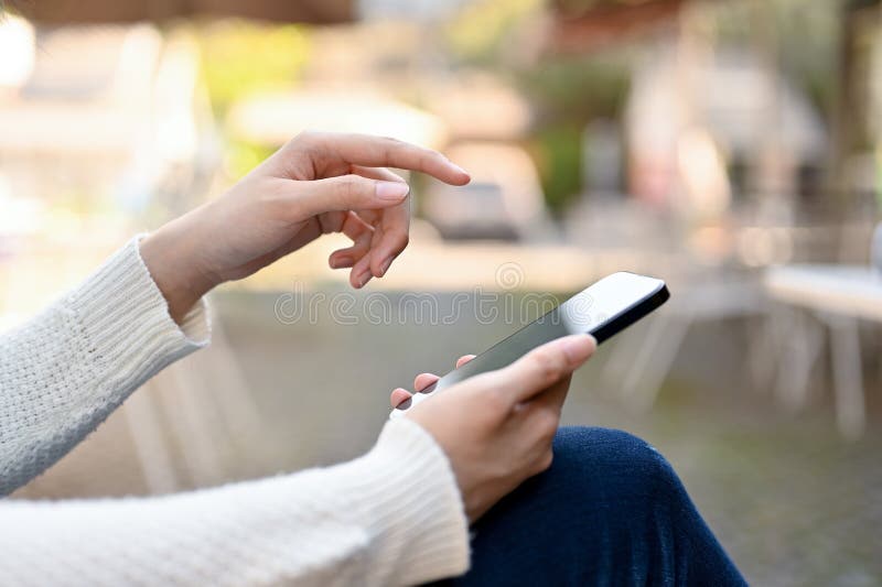 Close-up, Side View Image of a Woman Using Her Smartphone at the ...