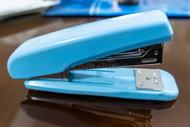 Close Up Side View of Light Blue Stapler Isolated on Glass Background ...
