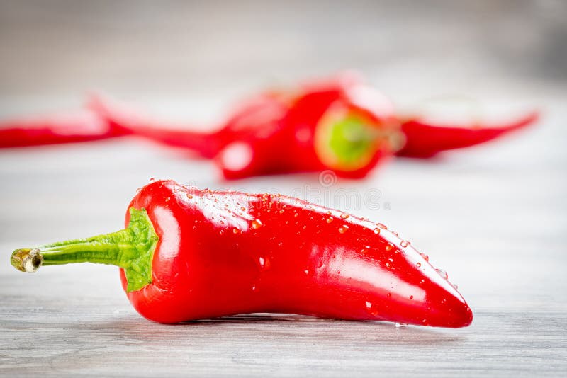 Close Up of a Single Red Pepper with Others in the Background Stock ...