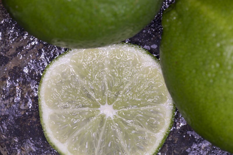 Close Up on Slice of Lime with Fresh Limes Stock Image - Image of lime ...