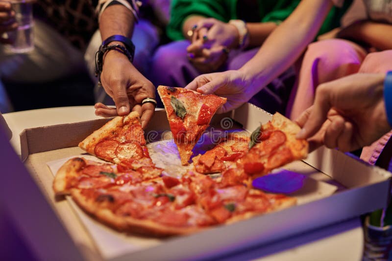 Close-up of Slices of Appetizing Pizza in Box Being Eaten by Friends ... Close-up of Slices of Appetizing Pizza in Box Being Eaten by Friends ...