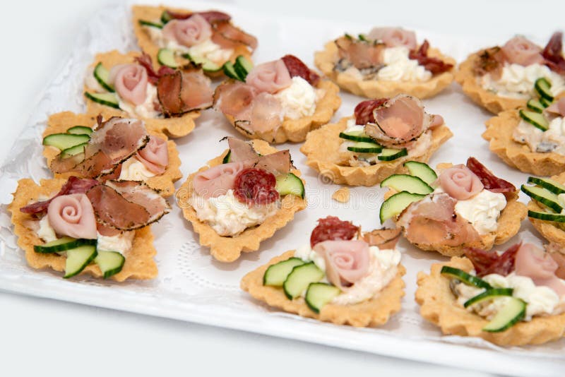 Close Up of Small Sweet Canapes Arranged on a Mirror Plate Over Light ...