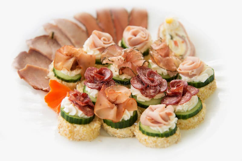 Close Up of Small Canapes Arranged on a Mirror Plate Over Light ...