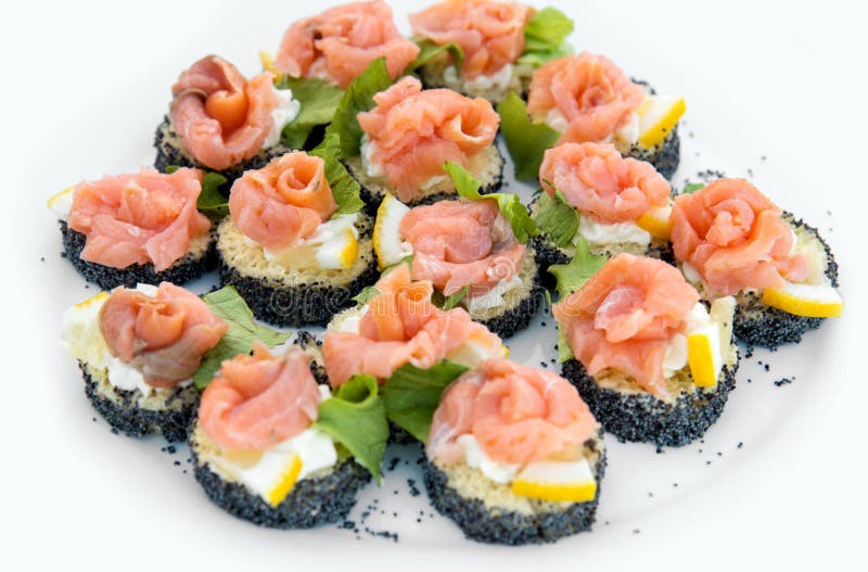 Close Up of Small Canapes Arranged on a Mirror Plate Over Light ...
