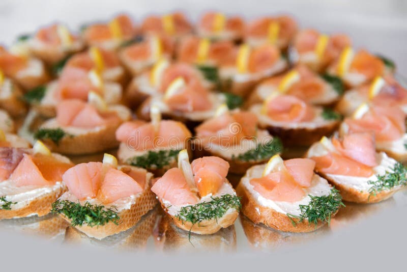 Close Up of Small Sweet Canapes Arranged on a Mirror Plate Over Light ...