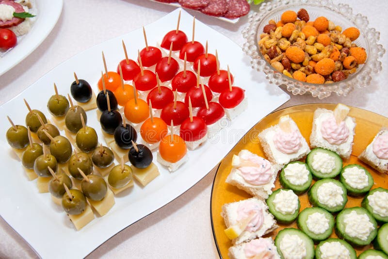 Close Up of Small Sweet Canapes Arranged on a Mirror Plate Over Light ...