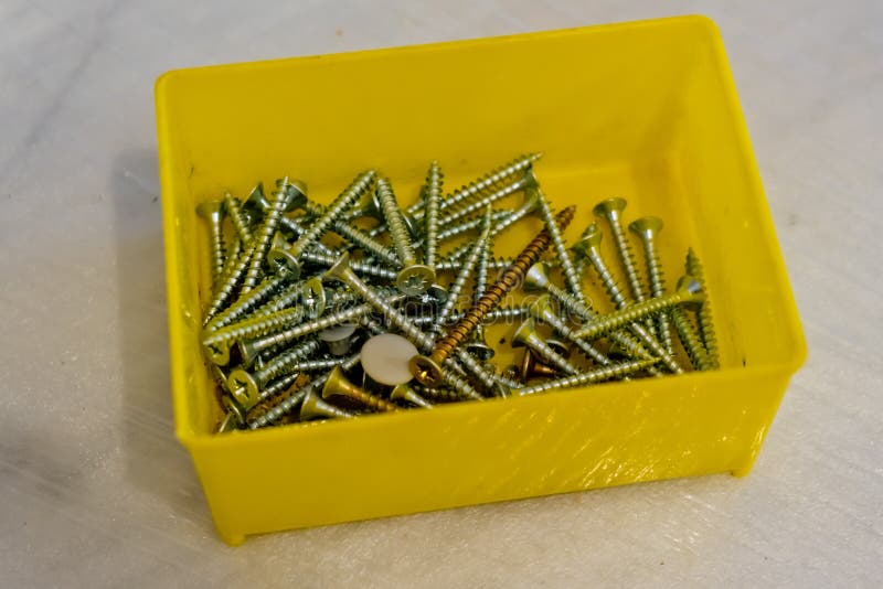 Close-up of Small Plastic Yellow Box with Different Screws and ...