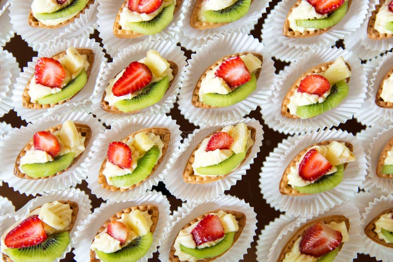Close Up of Small Sweet Canapes Arranged on a Mirror Plate Over Light ...