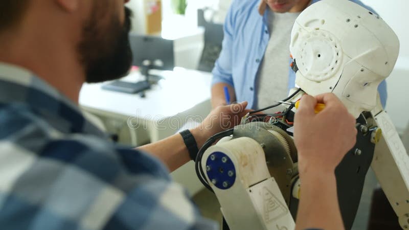 Two Engineers are Repairing a Human-like Robot Stock Video - Video of ...