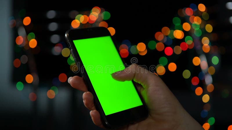 Close-up of a Smartphone with a Green Screen. Scrolling the Screen ...