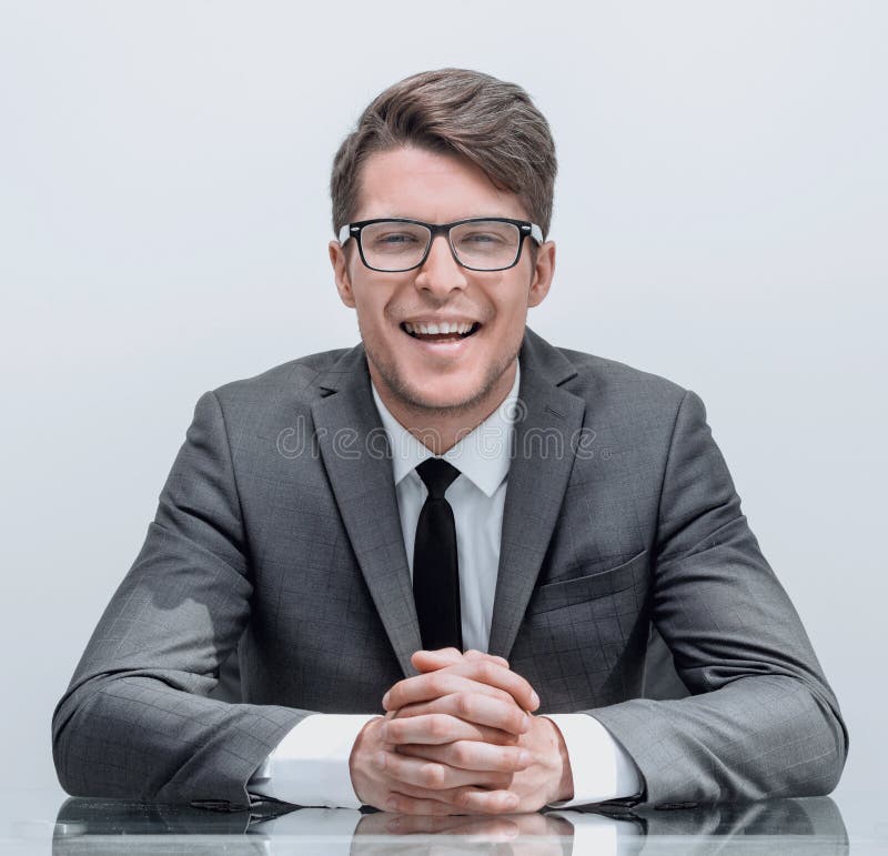Close Up. Smiling Businessman Sitting at His Desk Stock Photo - Image ... Close Up. Smiling Businessman Sitting at His Desk Stock Photo - Image ...