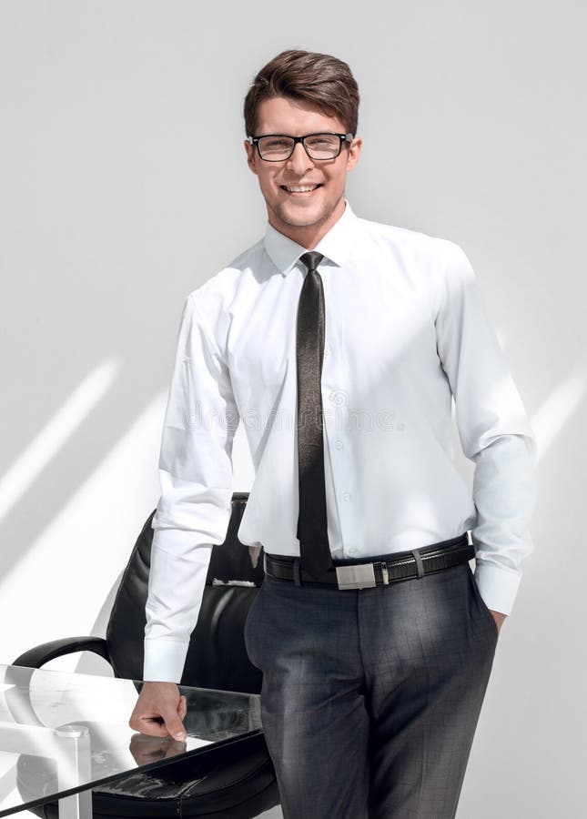 Close Up.smiling Businessman Standing Near His Desk Stock Photo - Image ... Close Up.smiling Businessman Standing Near His Desk Stock Photo - Image ...