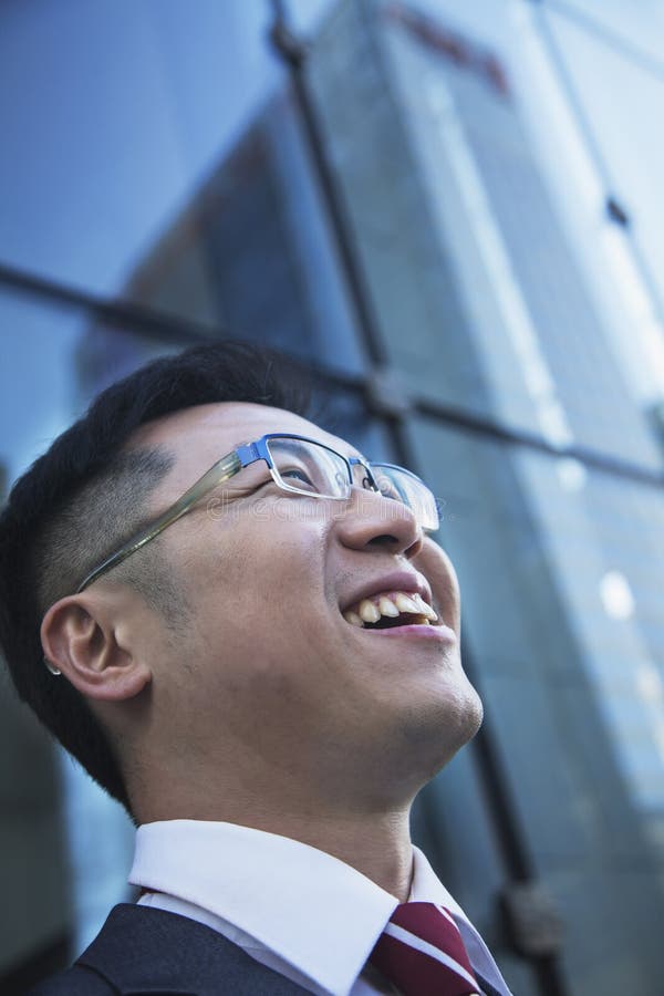 Close-up of Smiling and Laughing Businessman Looking Up with Glass ...