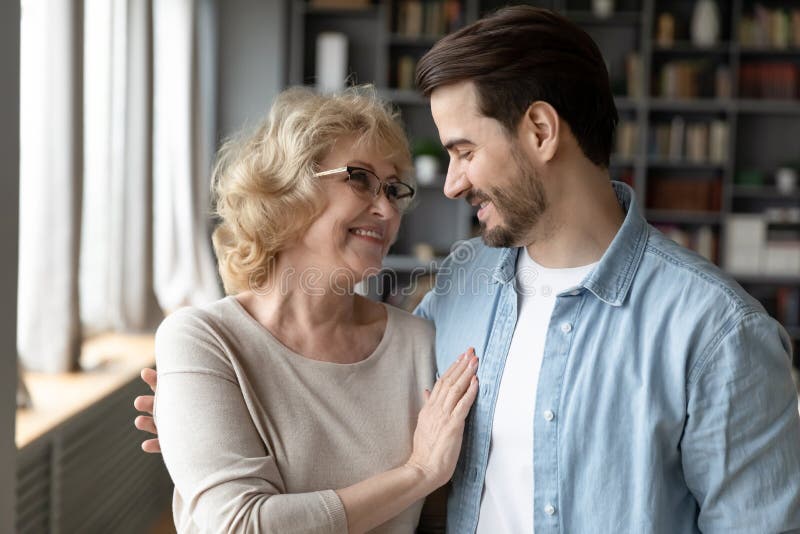 Close Up Smiling Mature Woman And Adult Son Hugging Stock Image Image