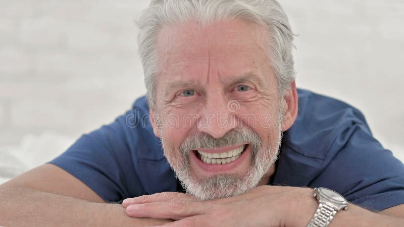 Close Up of Smiling Senior Old Man Lying in Bed and Looking at Camera ...