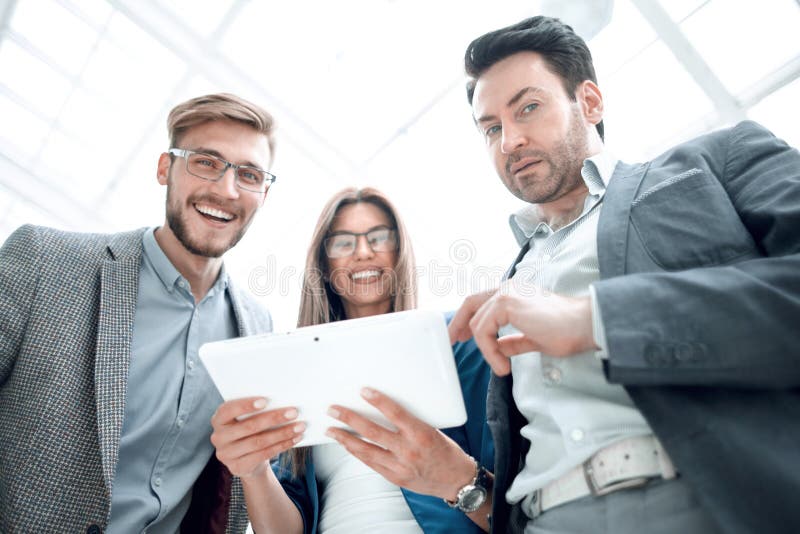 Close Up.smiling Staff Looking at the Digital Tablet Stock Photo ...