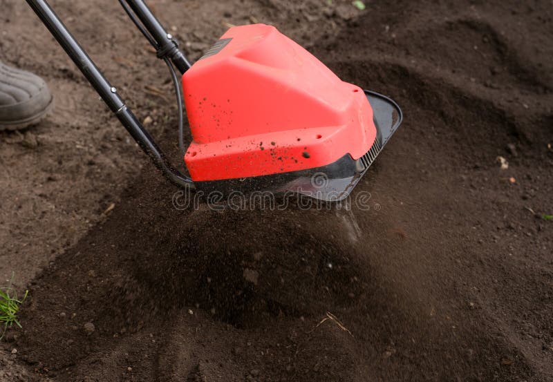 Close Up of Soil Being Tilled Using a Red Cultivator Stock Photo ...