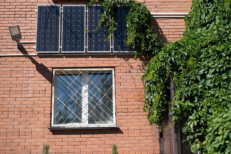 Close-up of Solar Panels on a Red Brick Wall. Alternative Energy Source ...