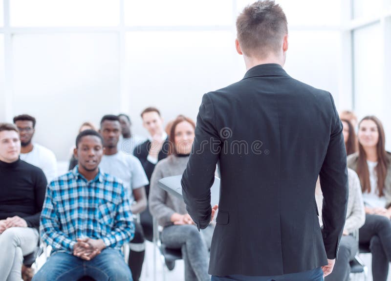 Close Up. Speaker Standing in Front of a Cheering Audience Stock Image ...