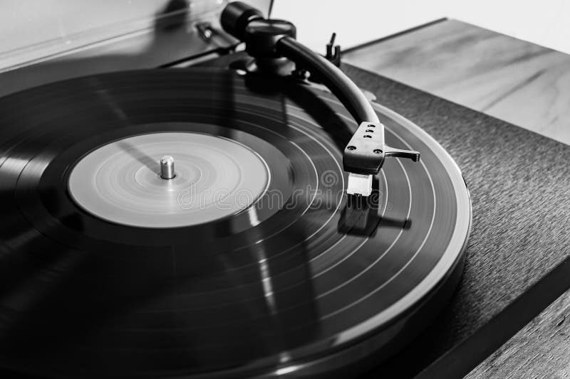 Close-up of a Spinning Vinyl Record on a Turntable with Tonearm and ...