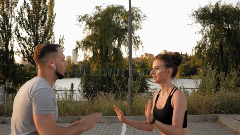 Close Up Of A Sporty Couple Clapping Their Hands At A Stadium After A