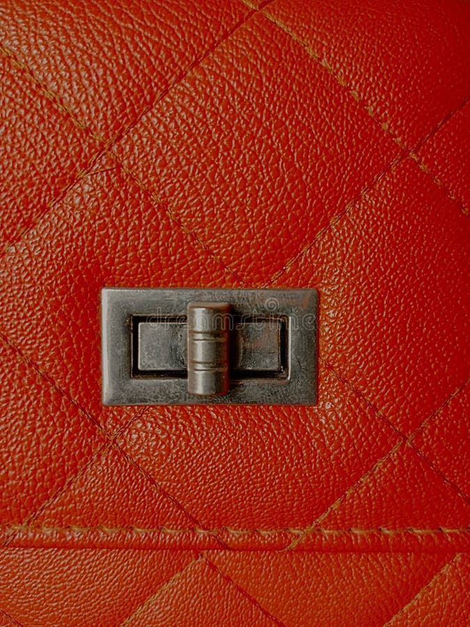 Square or Box Pattern on Orange Bag with Flap Showing Lock Button Stock ...