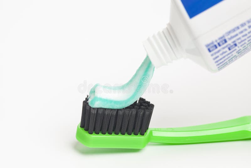 Close Up of Squeezing Toothpaste on Toothbrush on White Background ...