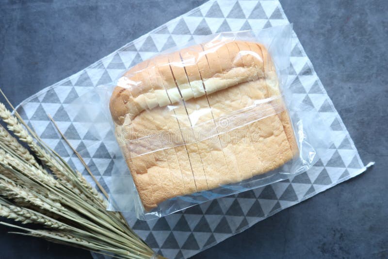 Top View of Baked Bread in a Plastic Packet on Black Background Stock ...