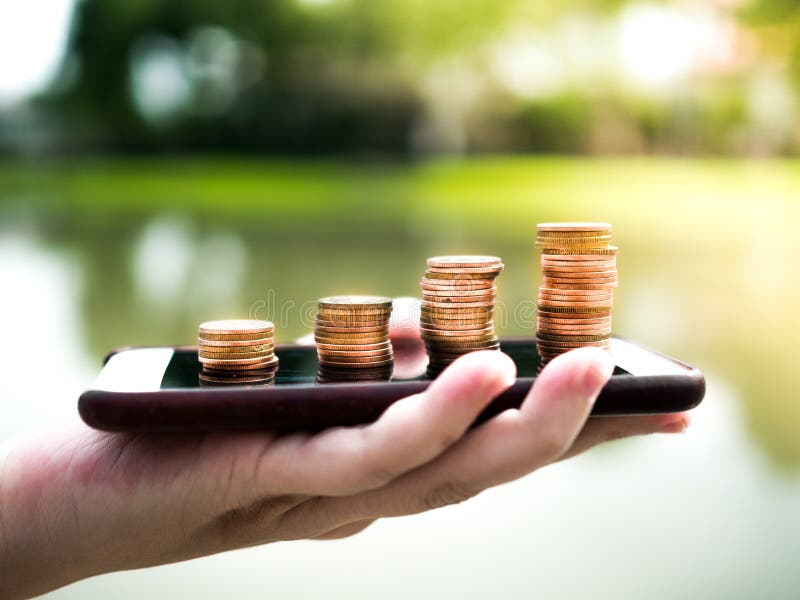 Close Up Stack of Money Coins on the Mobile Phone, Business in ...