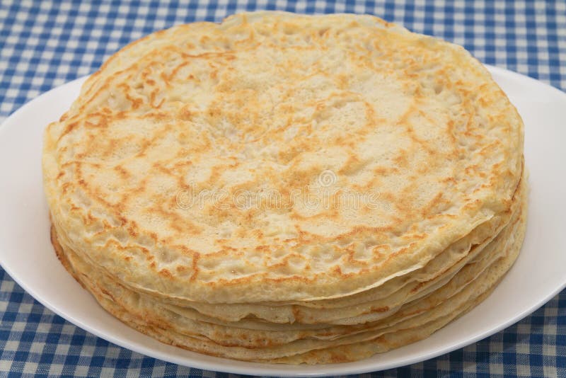 Close-up of a Stack of Pancakes on a White Plate and a Checkered Blue ...