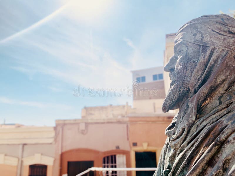 Close-up of a Statue with Some Buildings in the Background Stock Image ...